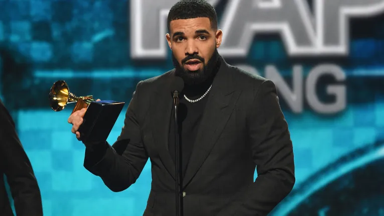 Drake Posts "Yeat Carry" T-Shirt, Uses Grammy As A Doorstop
