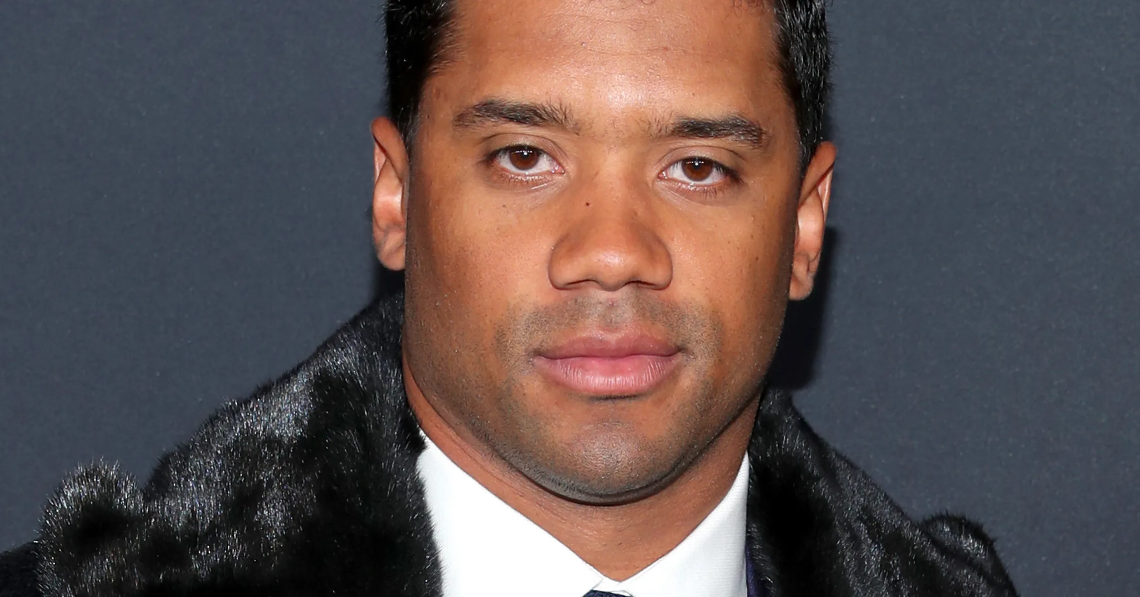 The Internet Is Trashing Russell Wilson's "Armed & Dangeruss" Poster